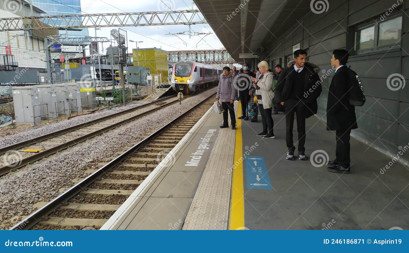 Trains at Train Station with Passenger Boarding in Editorial Photo ...
