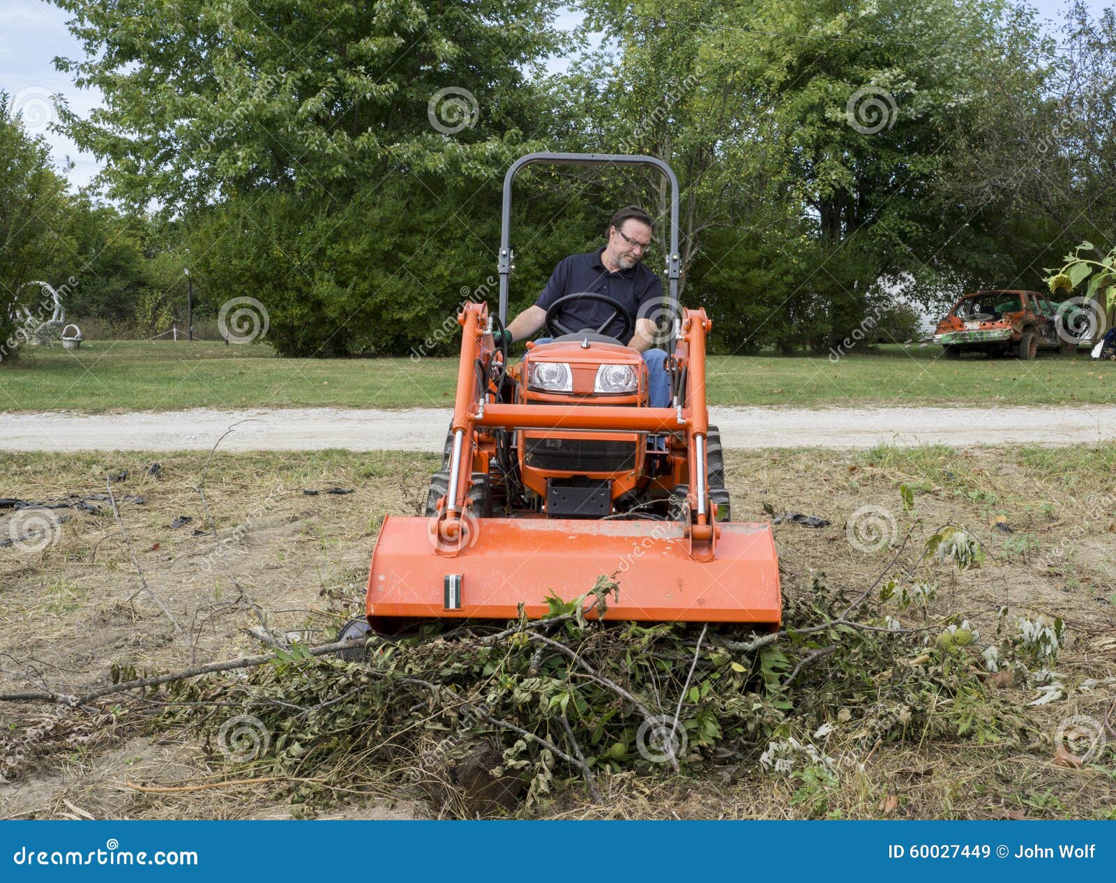 Tramping a Tree Limb Pile Down with a Front End Loader Stock Image ...