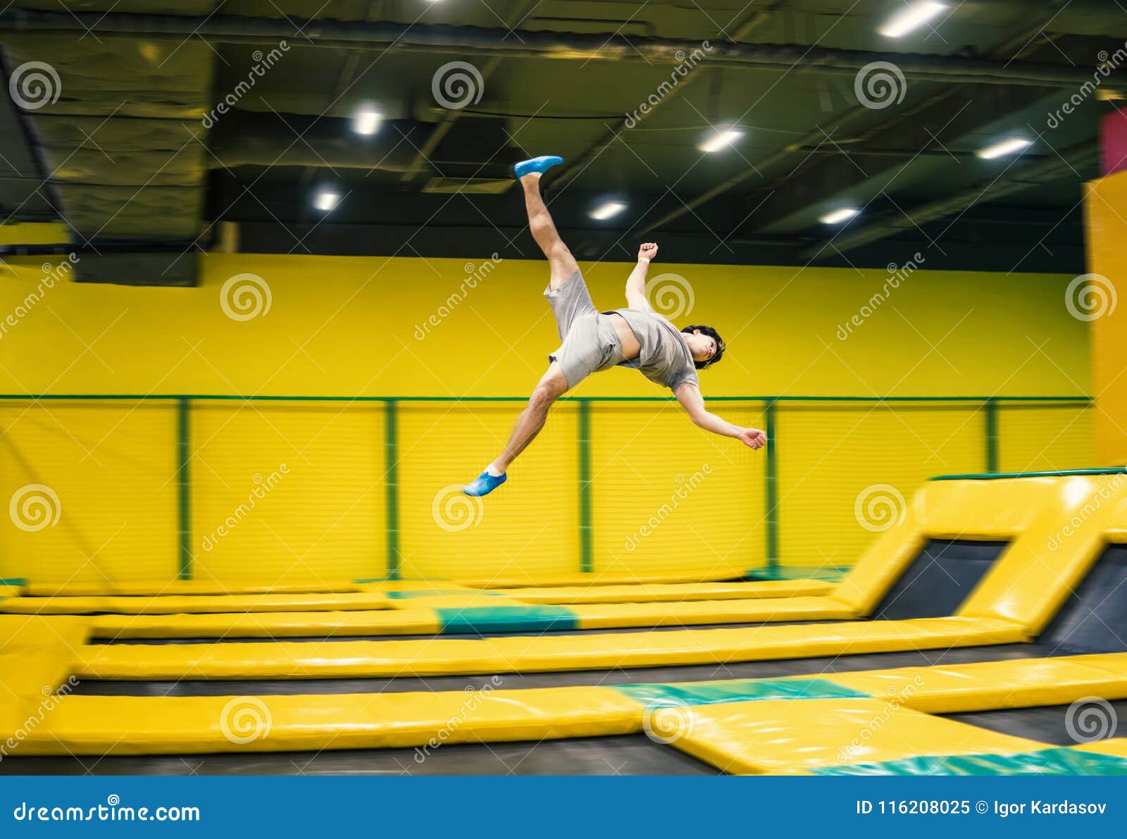 Trampoline Jumper Performs Acrobatic Exercises on the Trampoline Stock ...