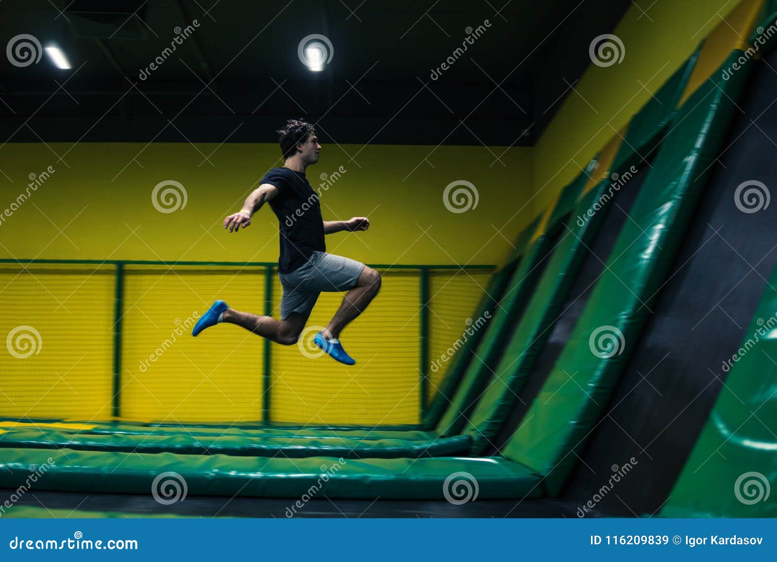Trampoline Jumper Performs Acrobatic Exercises on the Trampoline Stock ...