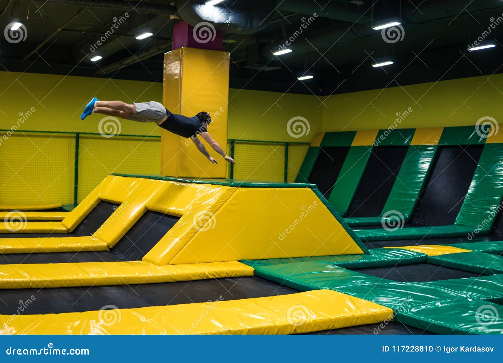 Trampoline Jumper Performs Acrobatic Exercises on the Trampoline Stock ...