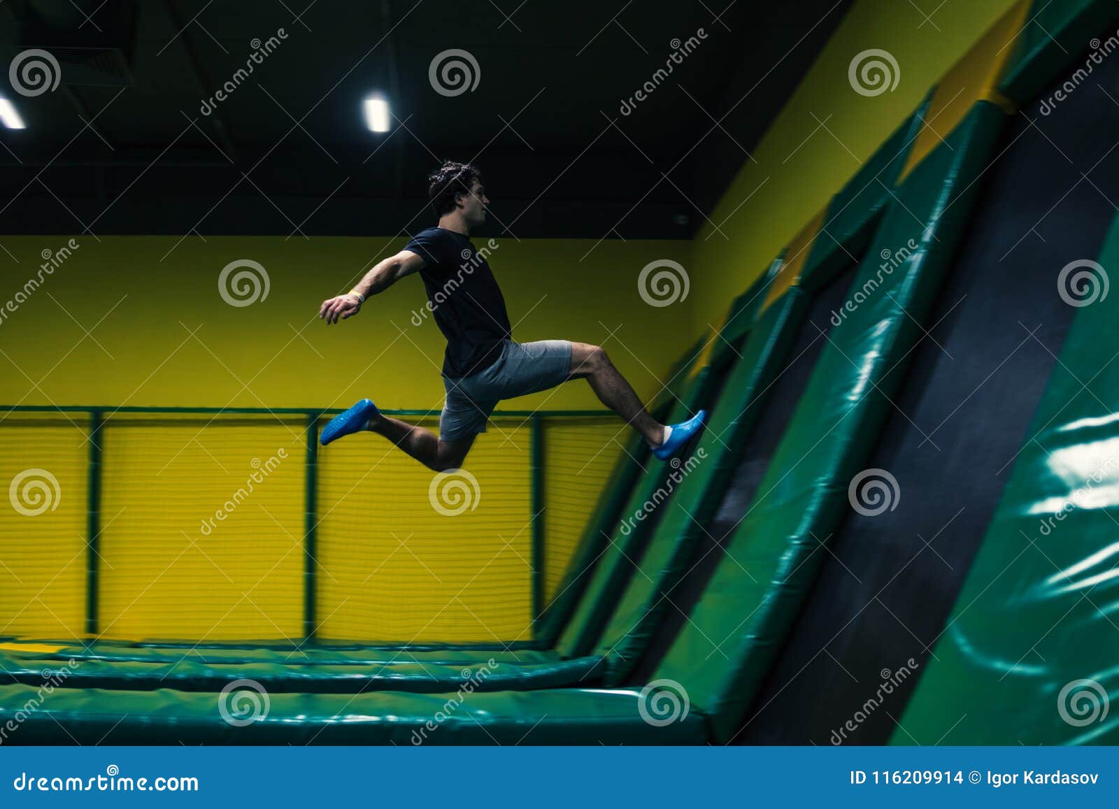 Trampoline Jumper Performs Acrobatic Exercises on the Trampoline Stock ...