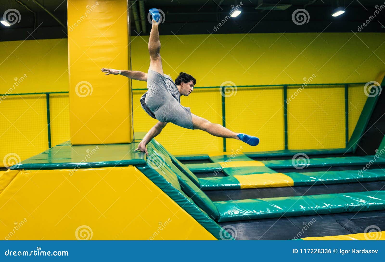 Trampoline Jumper Performs Acrobatic Exercises on the Trampoline Stock ...