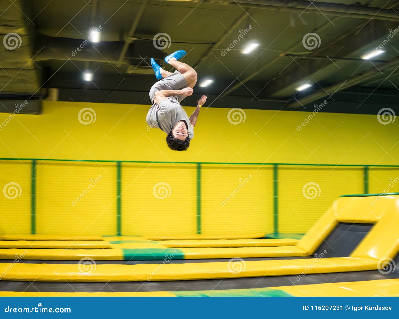 Trampoline Jumper Performs Acrobatic Exercises on the Trampoline Stock ...