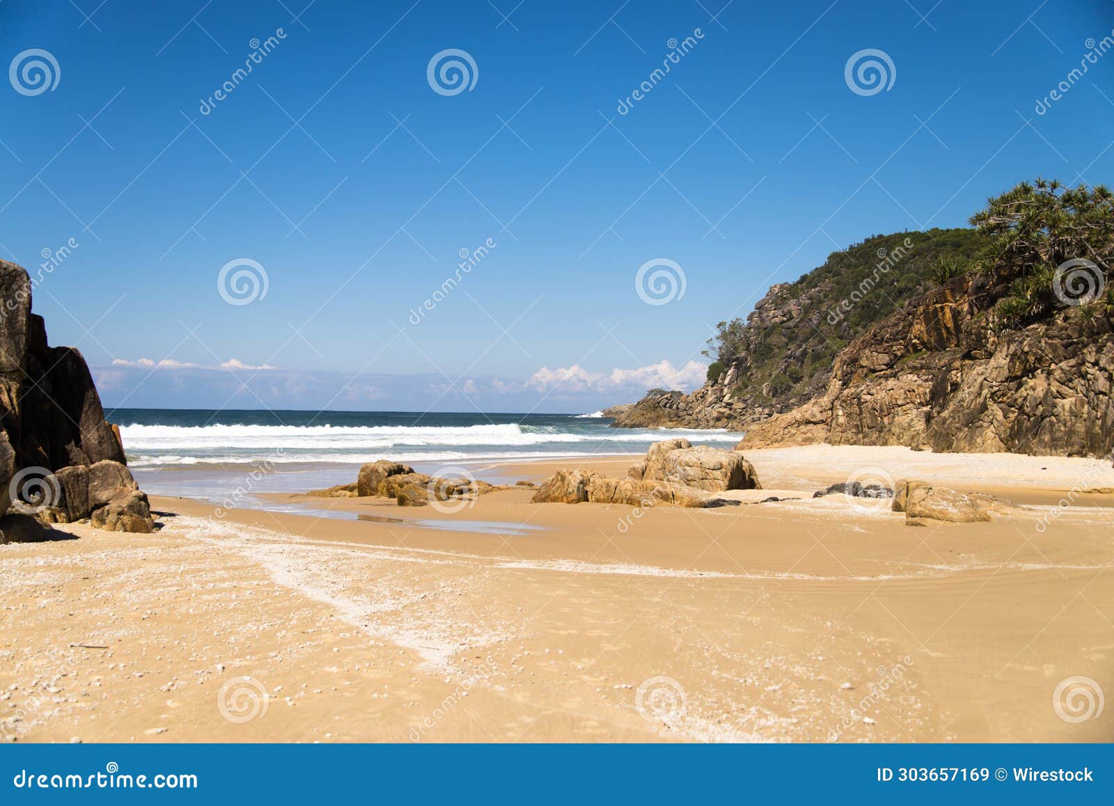 Tranquil Beach Scene with a Sandy Shoreline and Rolling Waves in the ...