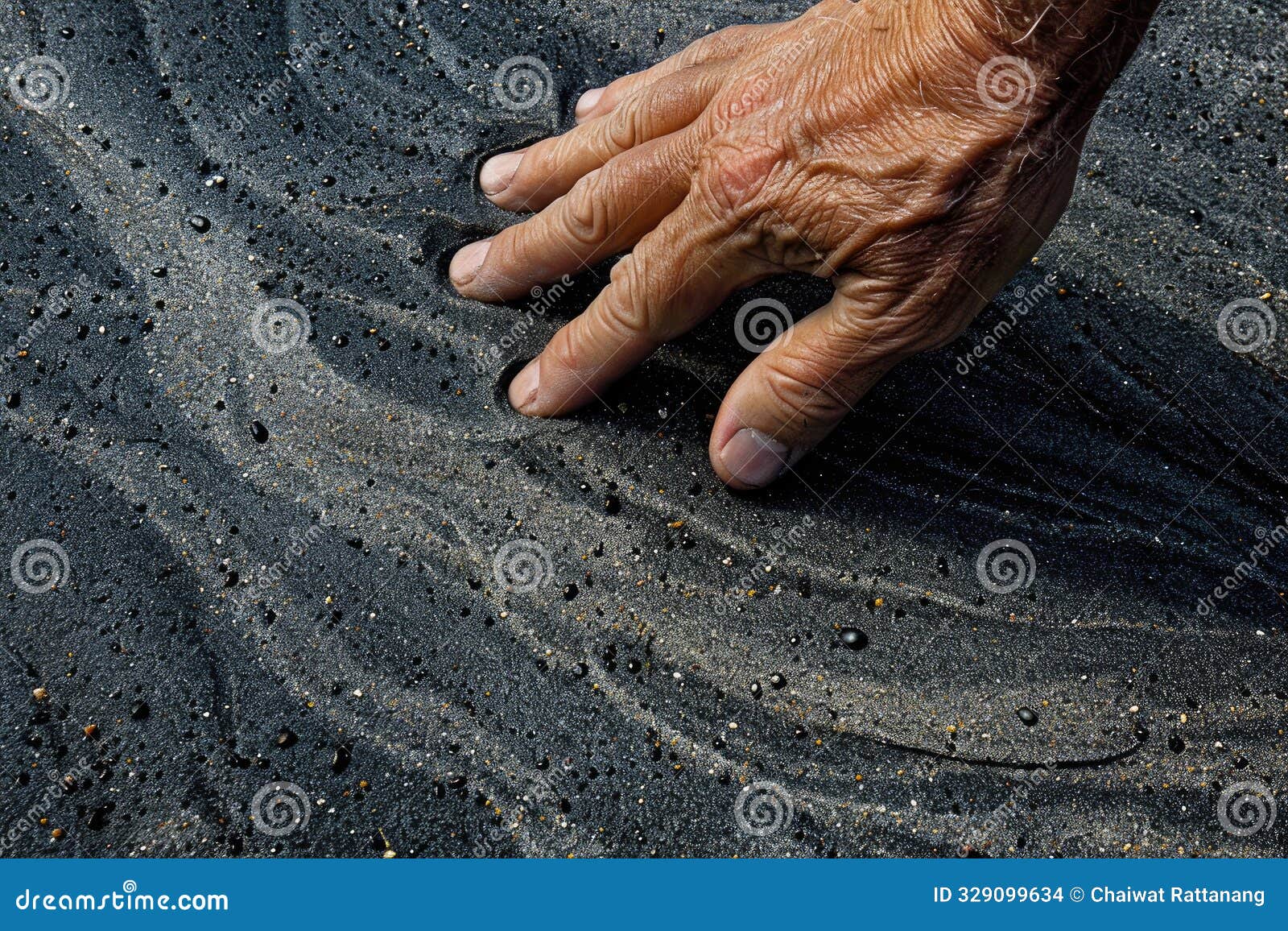Tranquil Beauty of Hand Drawing Patterns in Sand with Black Rock ...