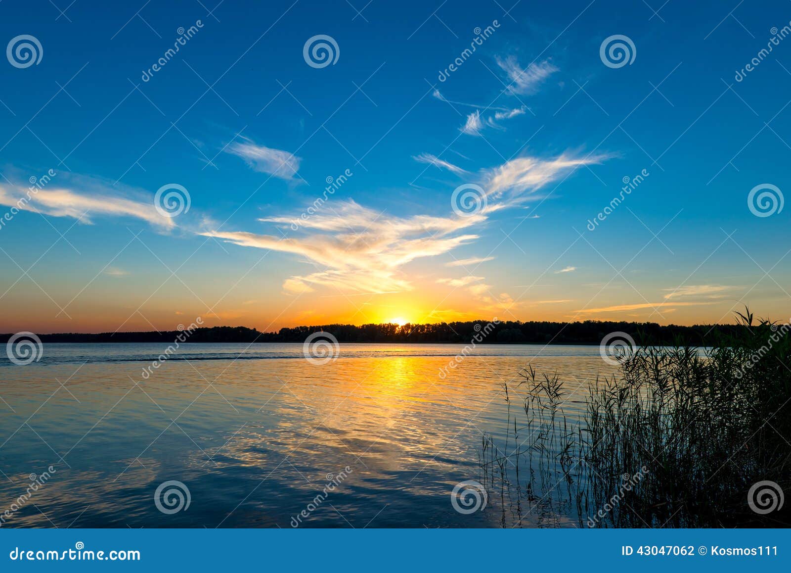 Tranquil Lake and the Setting Sun Stock Photo - Image of silhouette ...