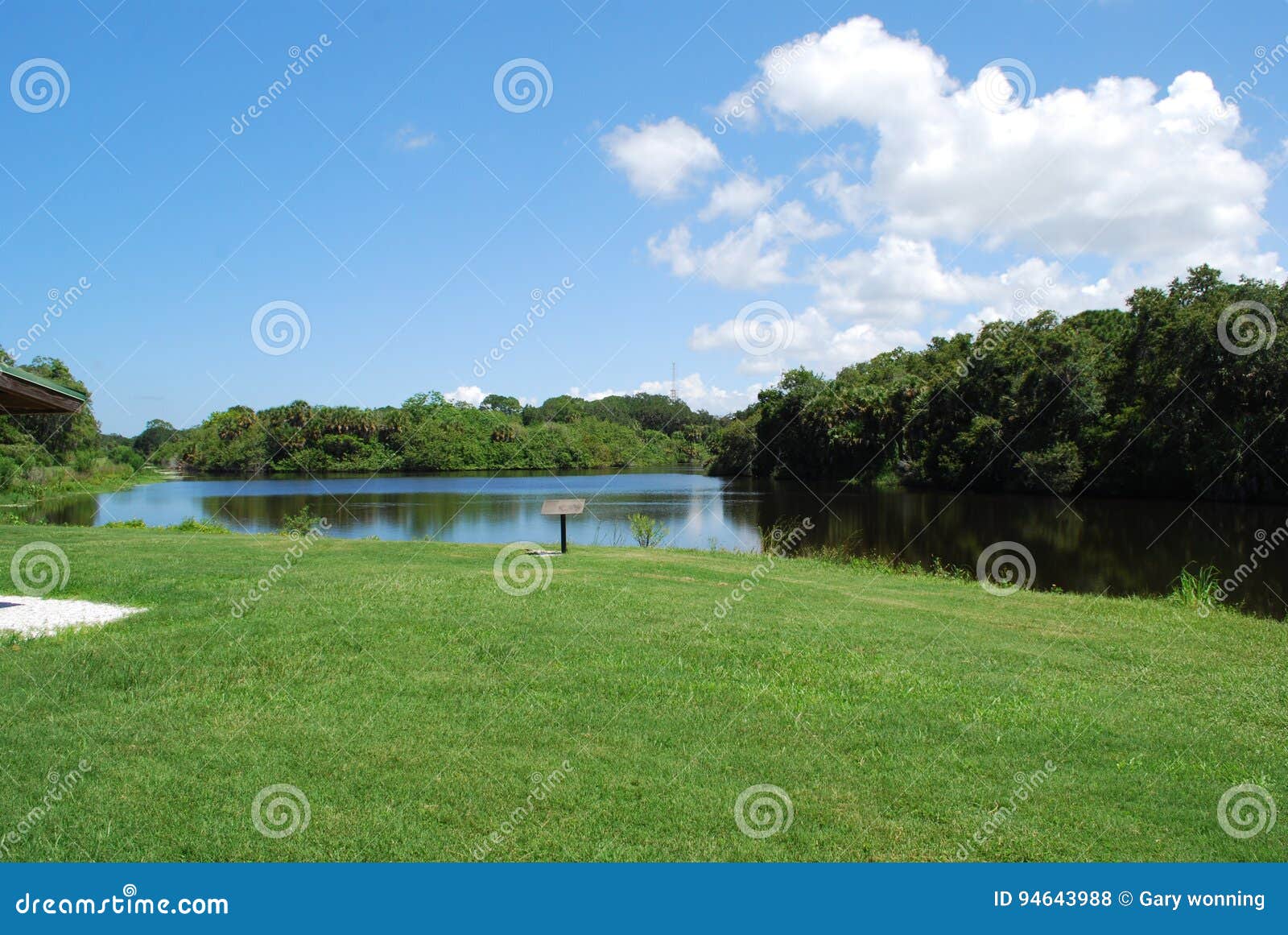 A Tranquil Lake Setting Under a Blue Sky Stock Photo - Image of stream ...
