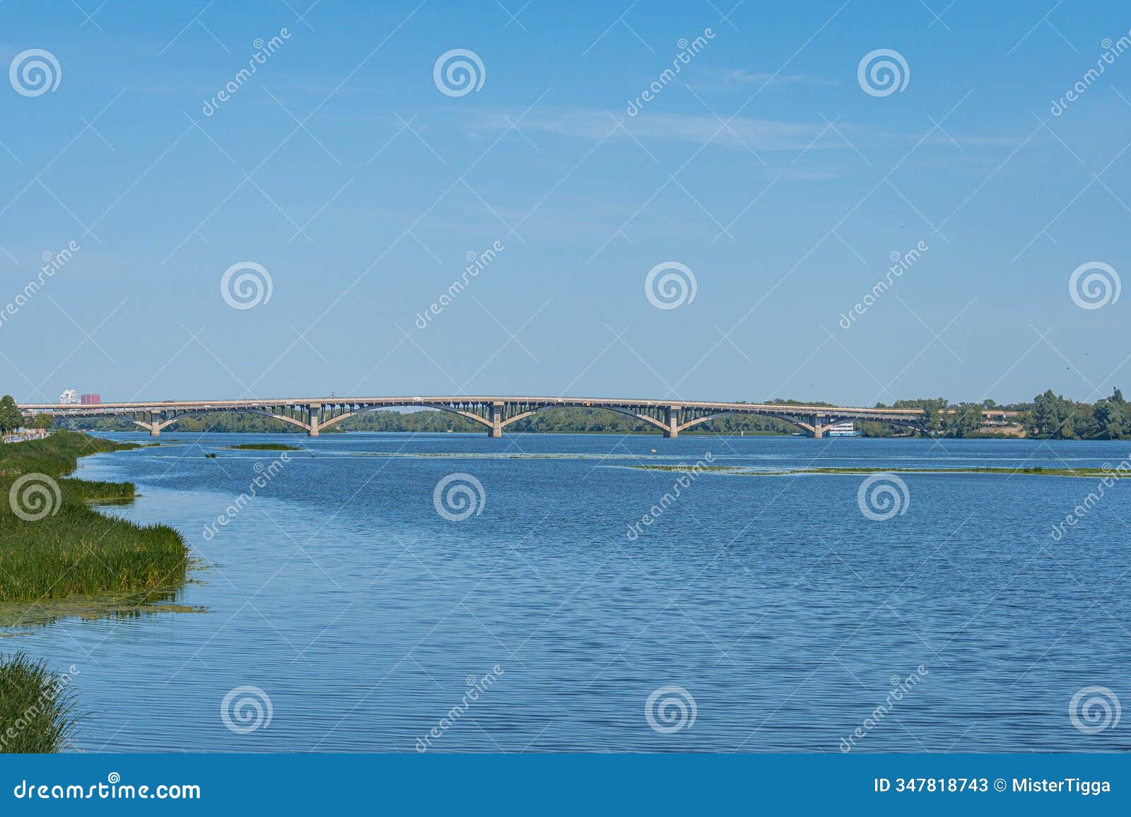 A Tranquil River Scene with Multiple Bridges, Under a Clear Blue Sky ...