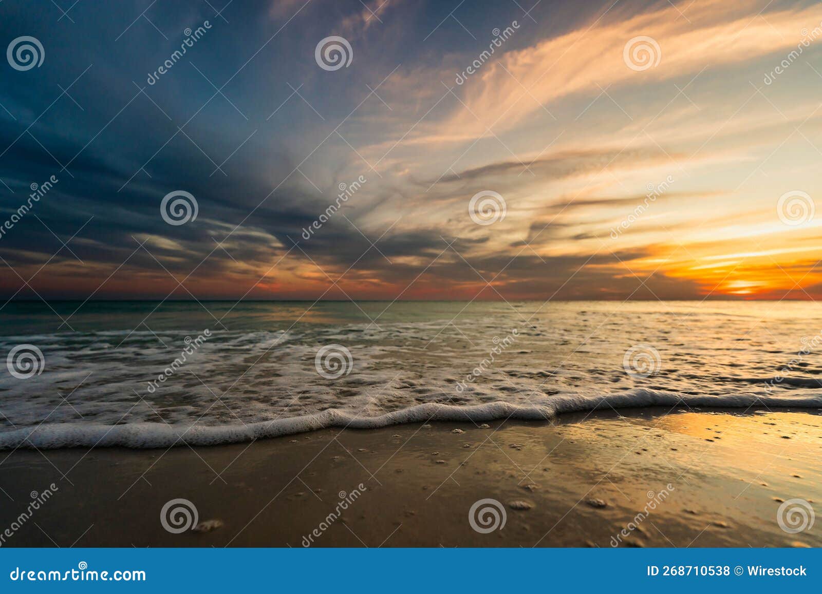 Tranquil Scenery of a Sandy Beach with Clouds and Sunset in the ...