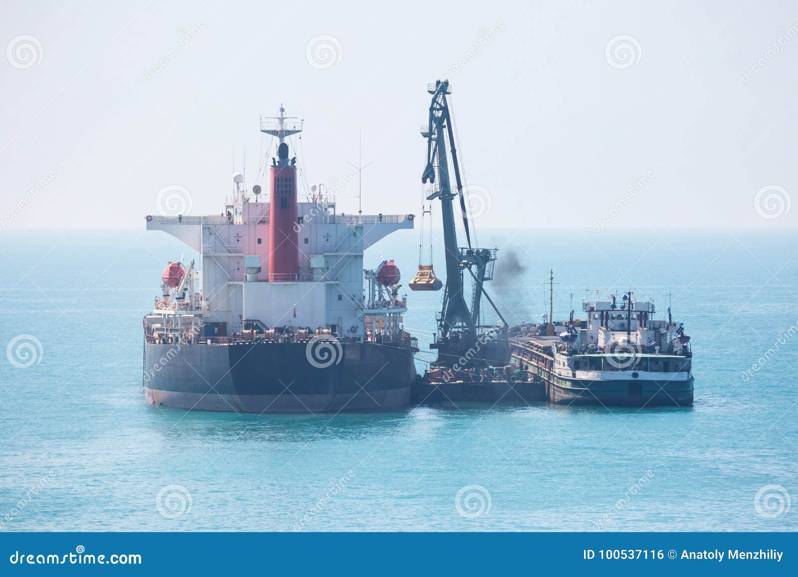 Dry Cargo Vessel Transferring a Cargo at Sea. Stock Photo - Image of ...