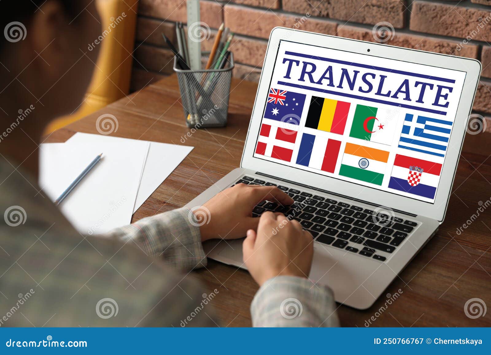 Translator Using Laptop with Images of Different Flags on Screen at ...