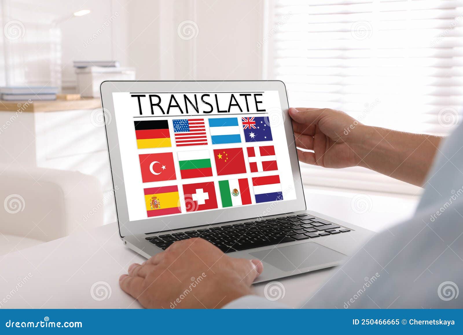 Translator Using Modern Laptop with Images of Different Flags on Screen ...