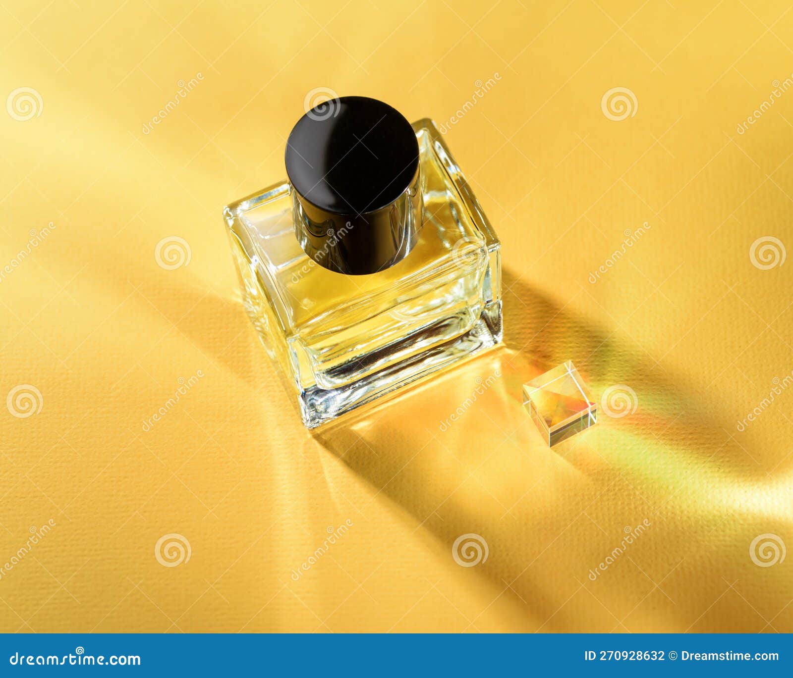 Transparent Bottle of Perfume on a Yellow Background with Sun Light ...