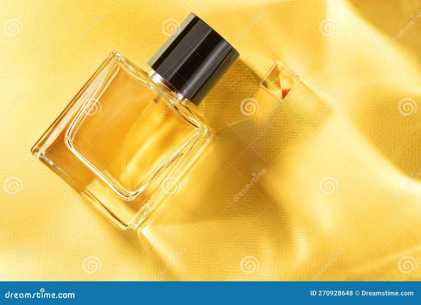Transparent Bottle of Perfume on a Yellow Background with Sun Light ...