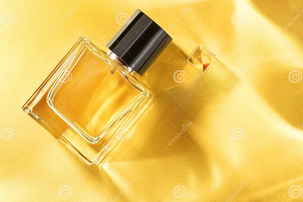 Transparent Bottle of Perfume on a Yellow Background with Sun Light ...
