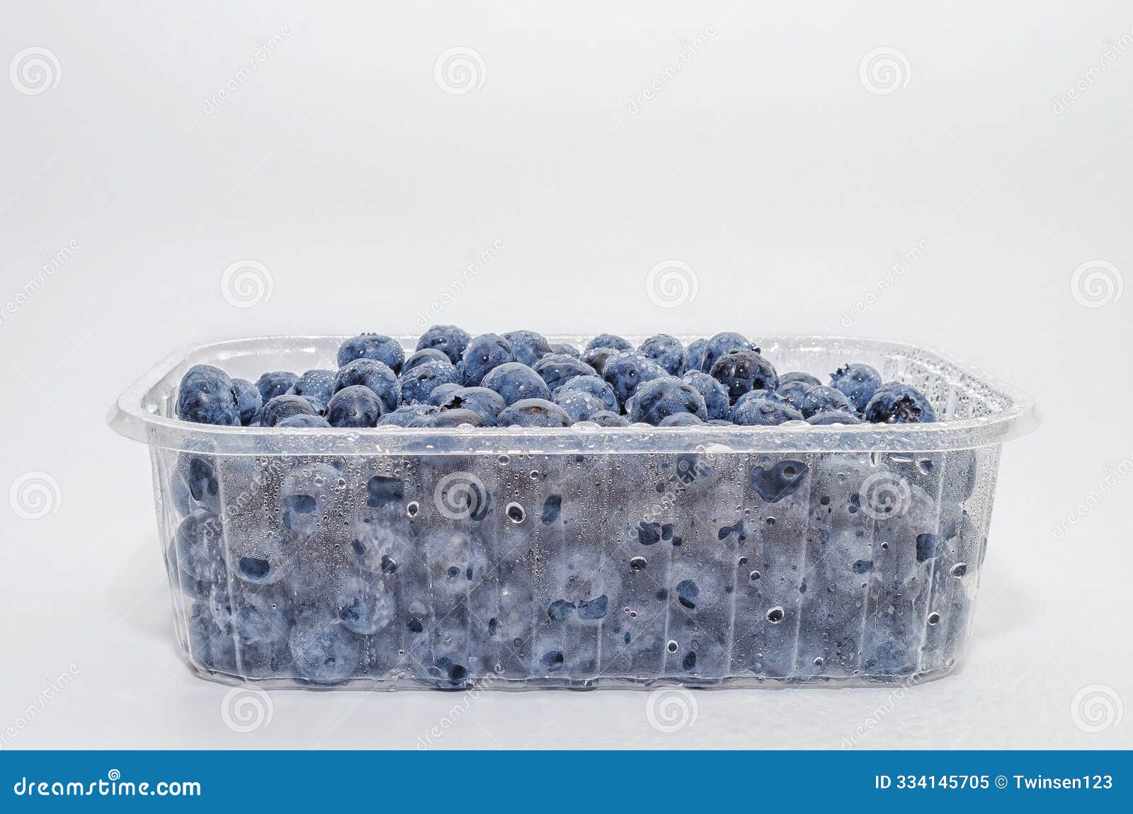 Transparent Container with Fresh Blueberries. Isolated on White. Side ...