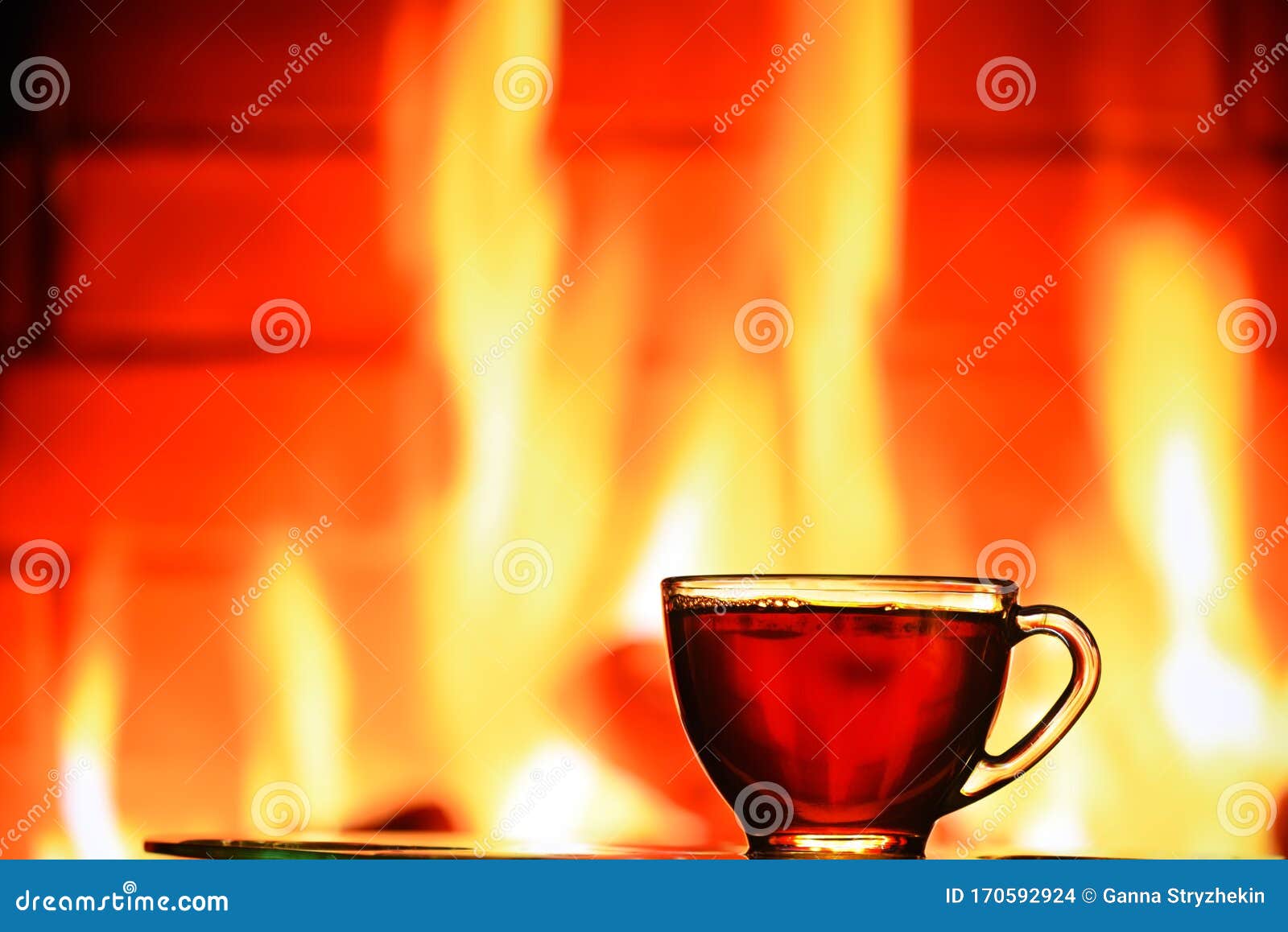 A Transparent Cup with Black Tea on a Background of Burning Fire. Stock ...