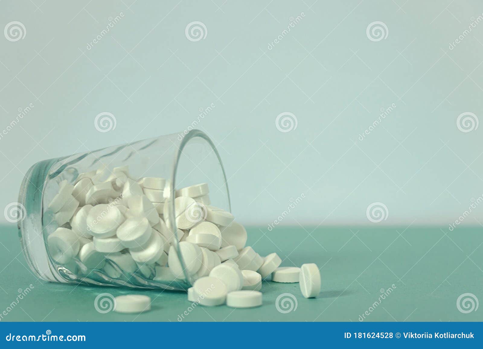 Transparent Glass Cup with White Round Tablets on the Table Stock Photo ...