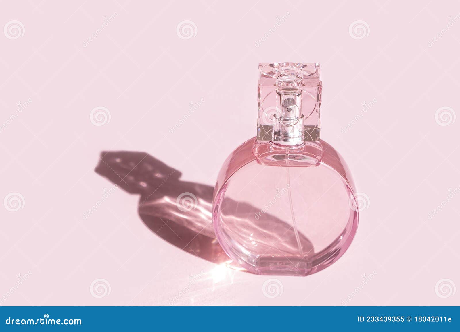 Transparent Pink Perfume Bottle on Pink Background with Strong Shadow ...