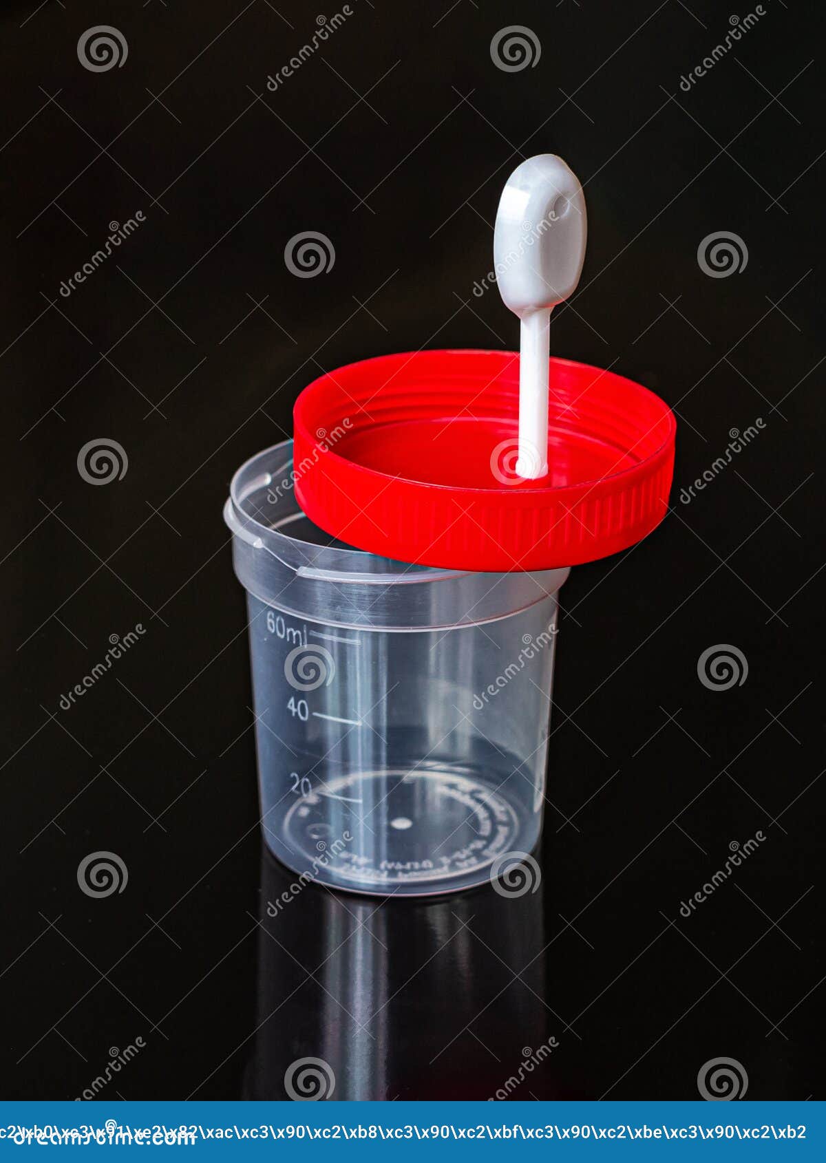 Transparent Container with a Red Lid and a Small White Spoon on a Dark ...