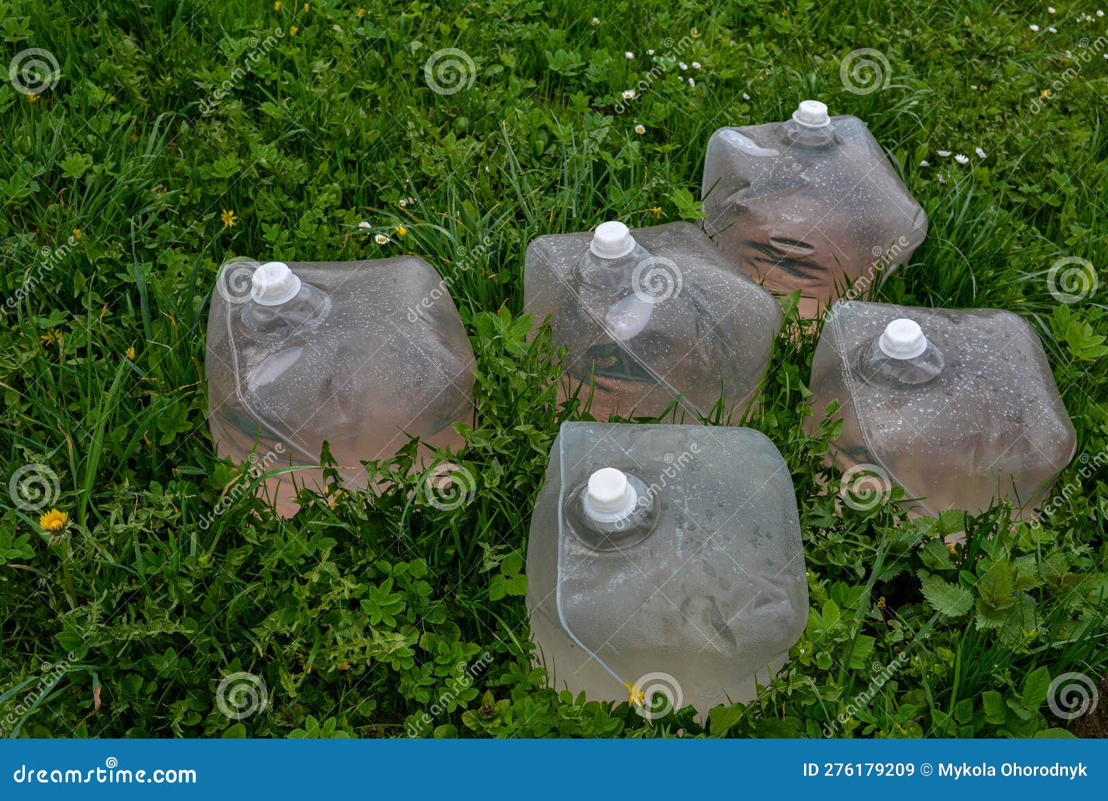 Transparent Plastic Cube for Water Storage , on Green Grass Stock Image ...