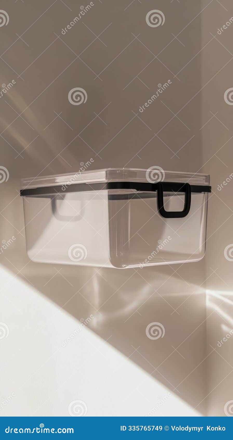 Transparent Plastic Storage Box with Black Handles on Sunlit Surface ...