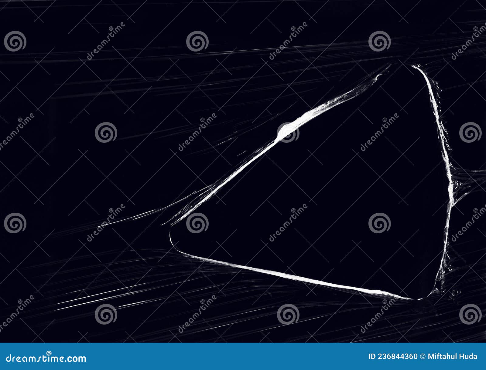 A Transparent Plastic Wrap with a Hole on Black Background. Stock Photo ...