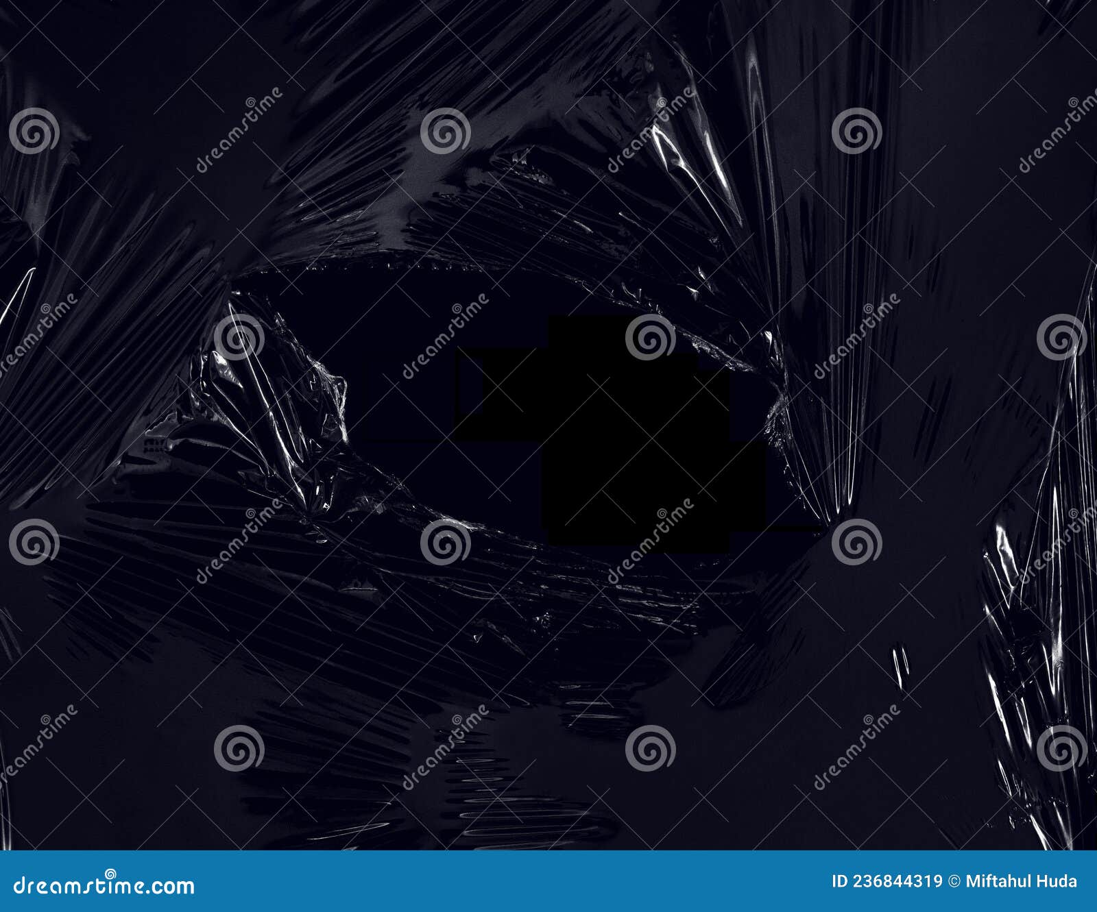 A Transparent Plastic Wrap with a Hole on Black Background. Stock Image ...