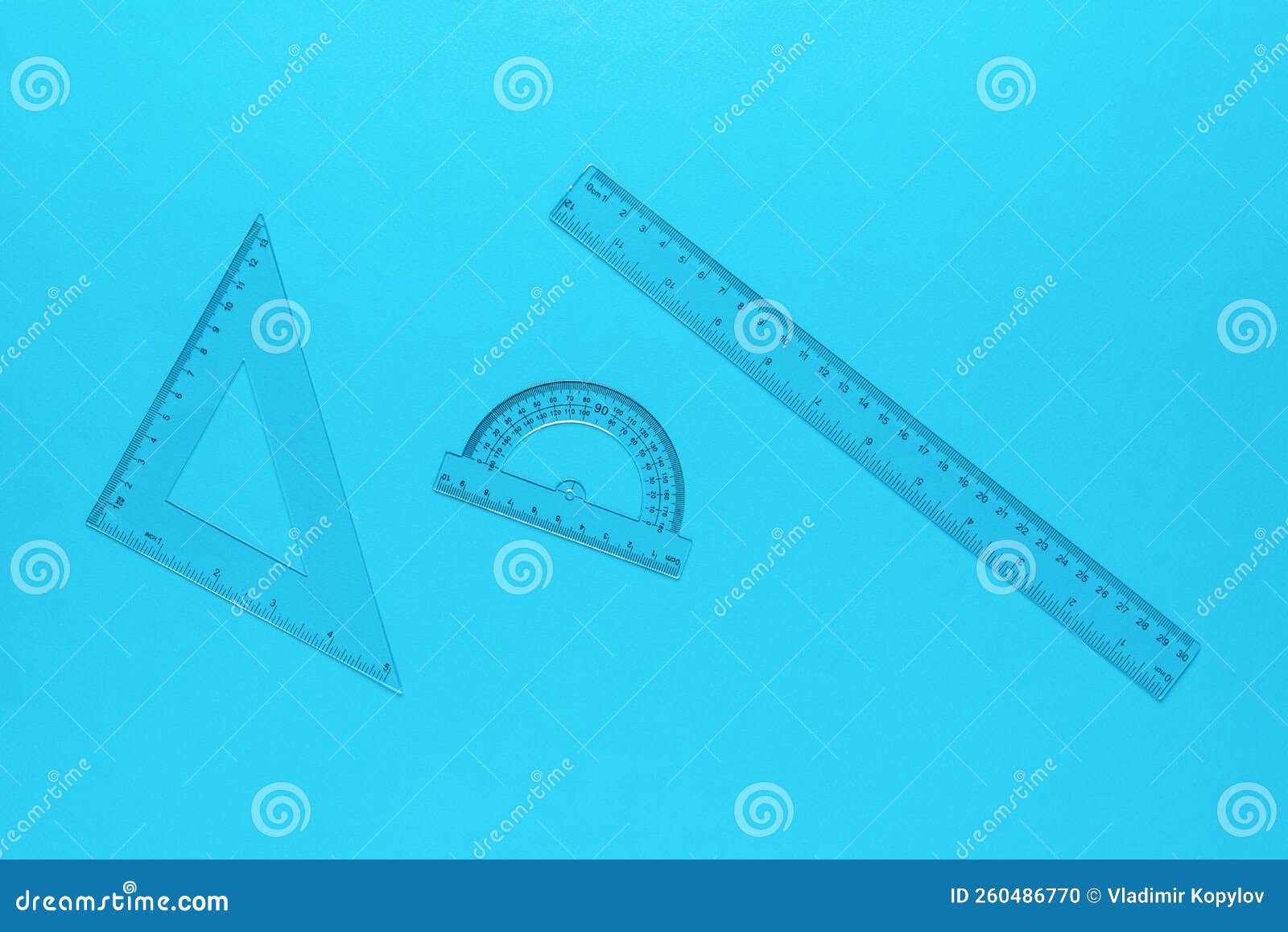 Transparent Ruler, Triangle Protractor on a Blue Background Stock Photo ...