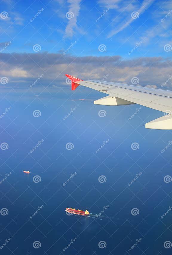 Cargo Ships Under Wing of Flying Plane Stock Image - Image of transport ...