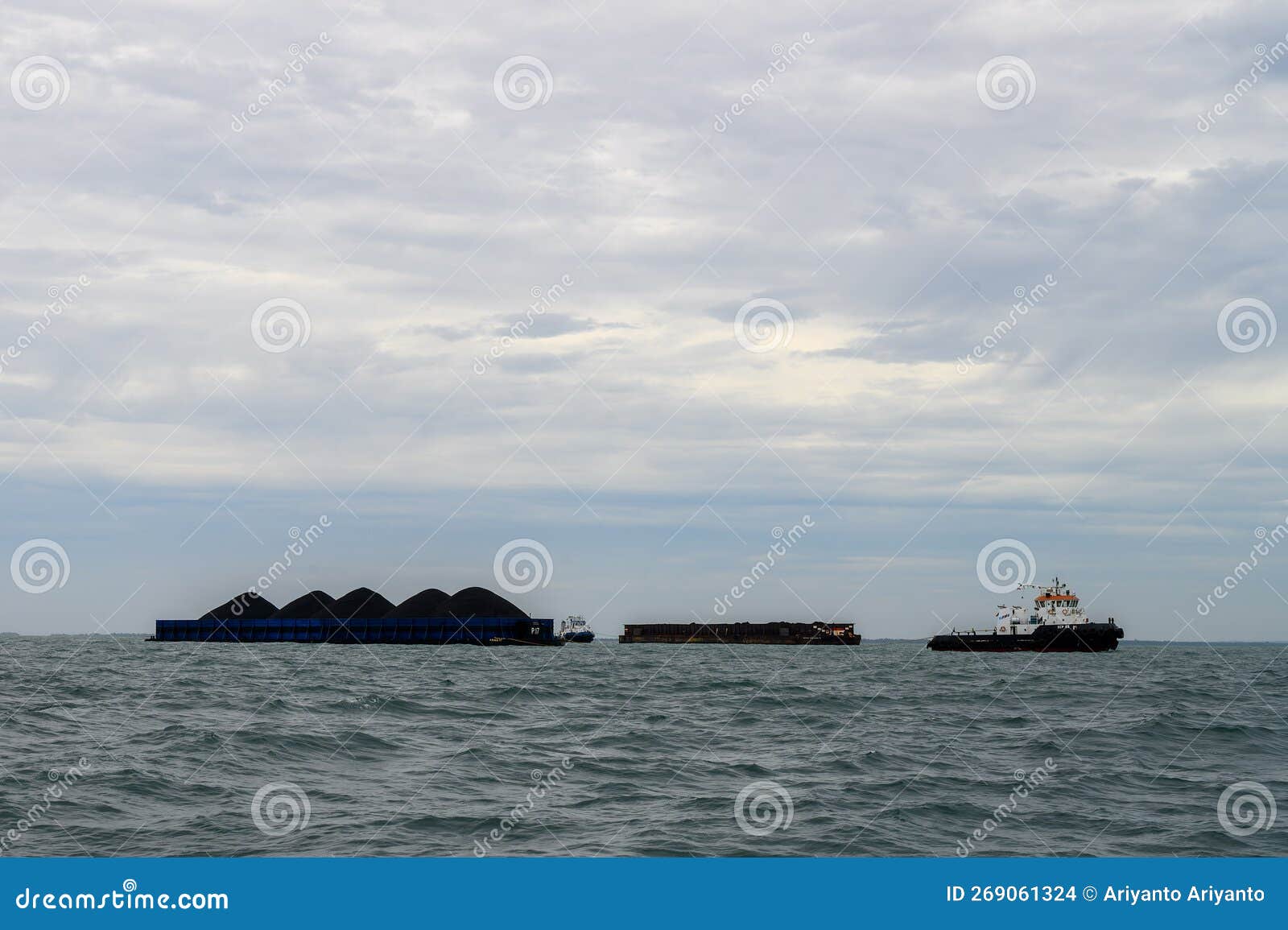Transporting Coal into Large Ships in the Middle of the Sea Stock Photo ...