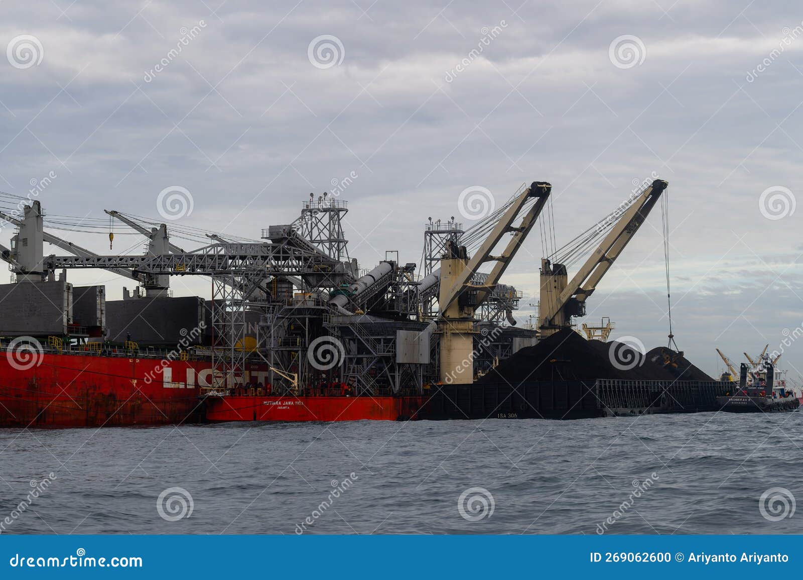 Transporting Coal into Large Ships in the Middle of the Sea Stock Photo ...