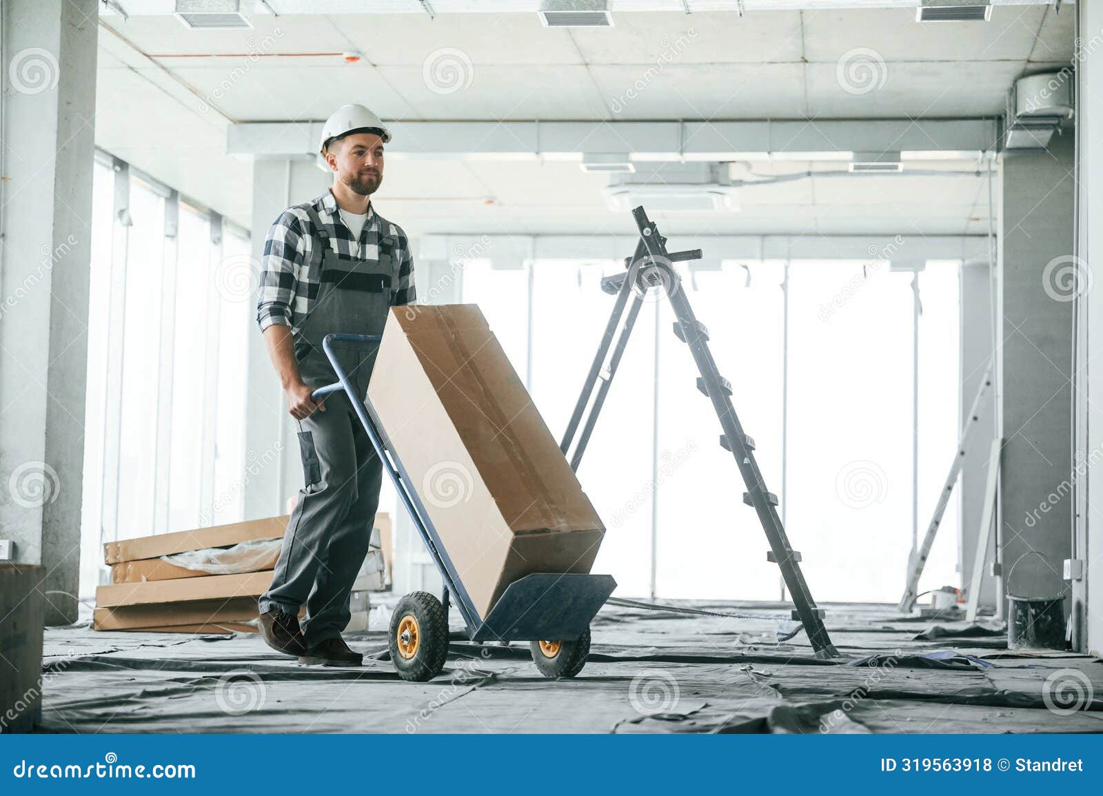 Transporting Long Paper Box. Construction Worker in Uniform in Empty ...