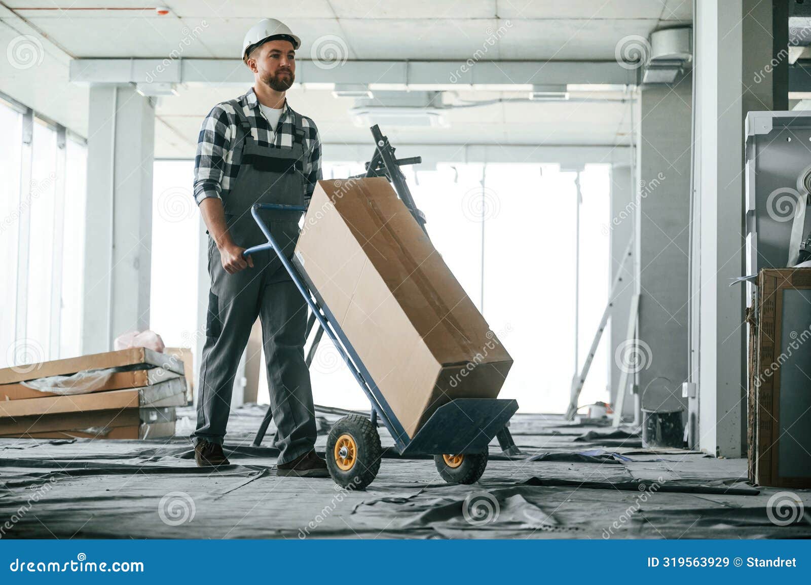 Transporting Long Paper Box. Construction Worker in Uniform in Empty ...