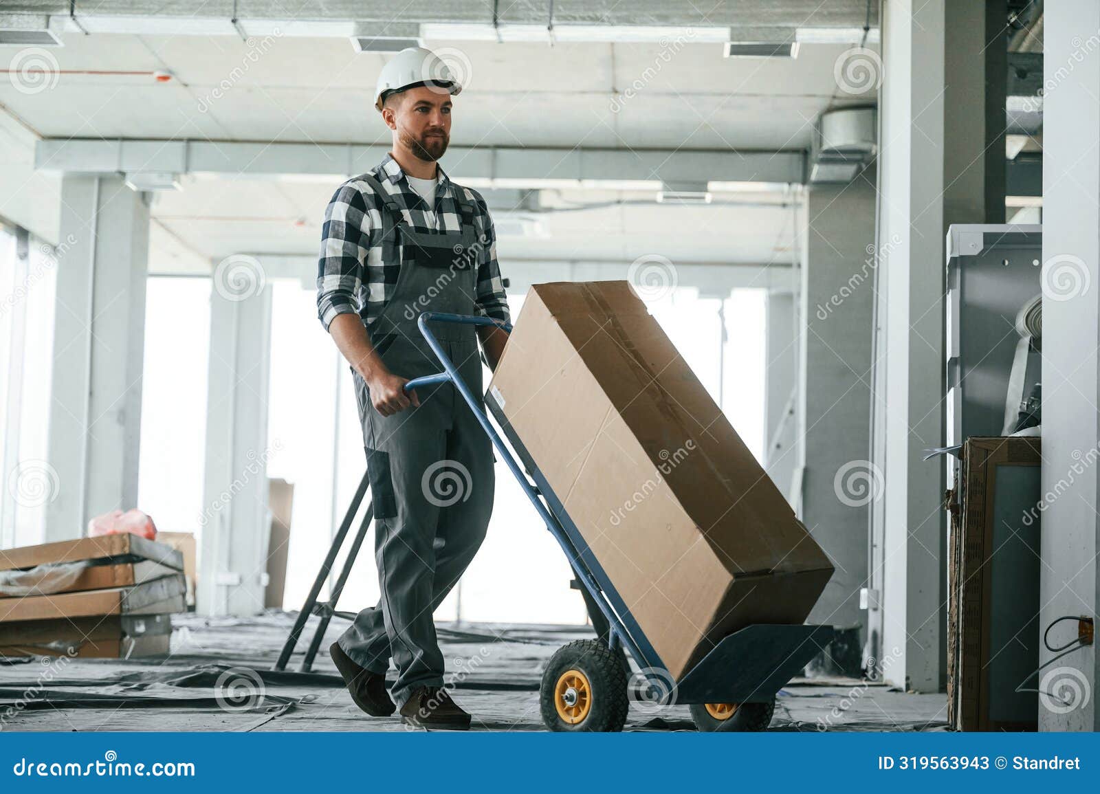 Transporting Long Paper Box. Construction Worker in Uniform in Empty ...