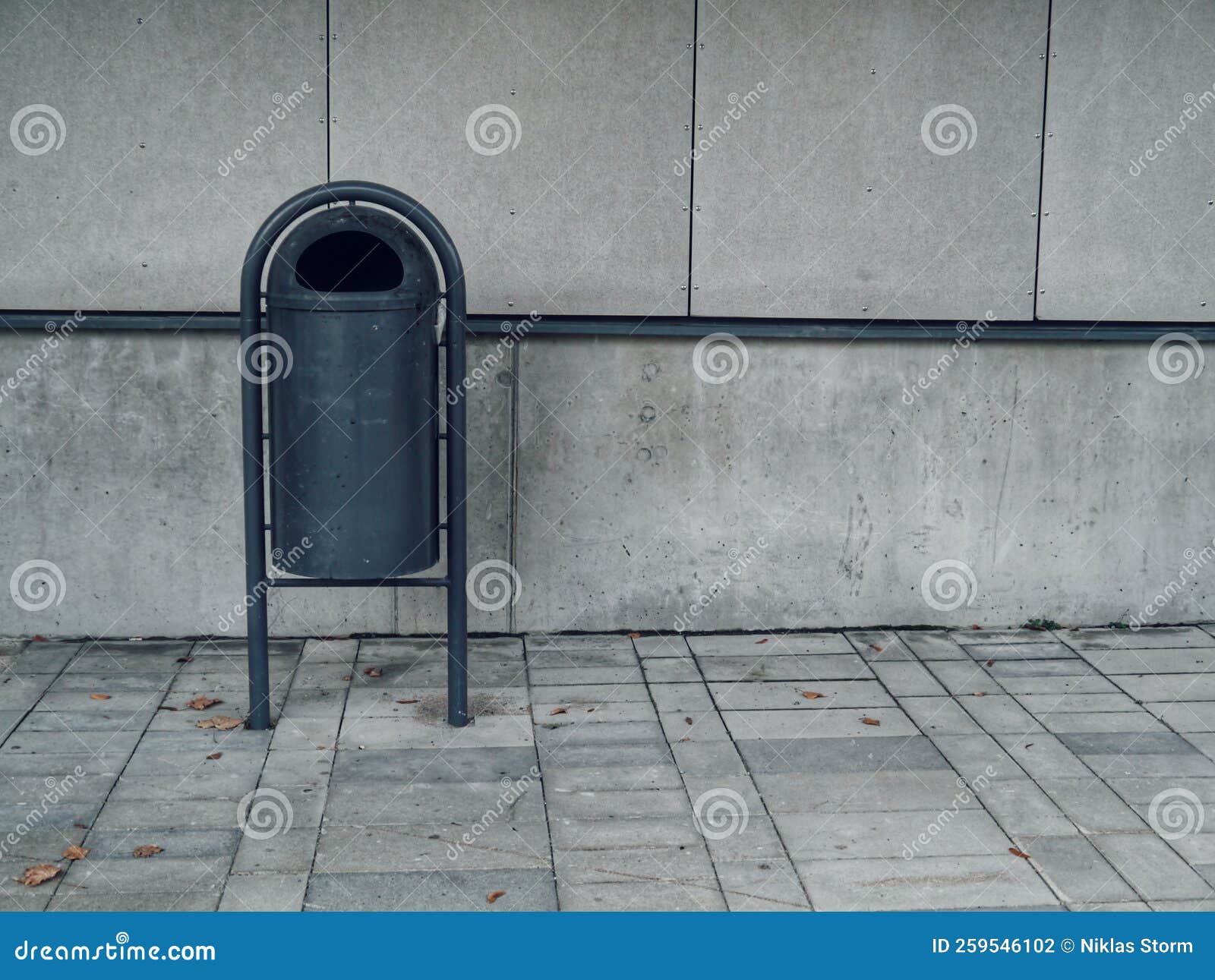 Trash Can Outdoors in Front of Concrete Wall Stock Photo - Image of ...