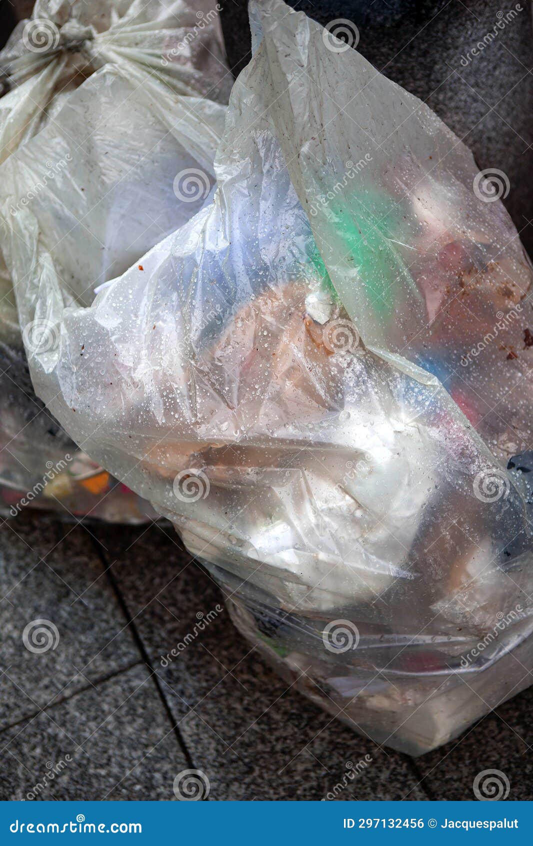 Trash Can on a Sidewalk in the Rain Stock Photo - Image of paper, trash ...
