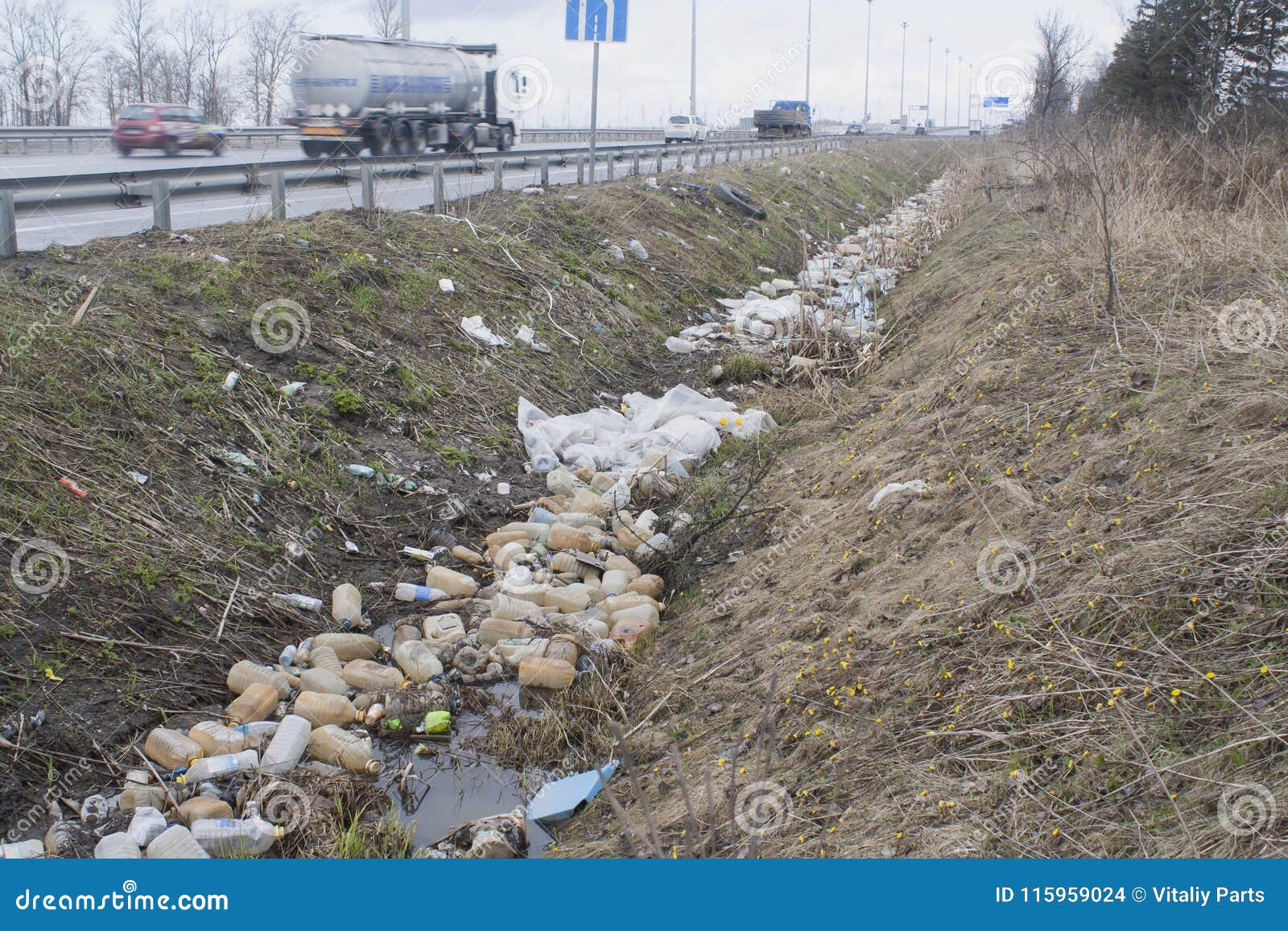 Trash in a roadside ditch stock photo. Image of problem - 115959024