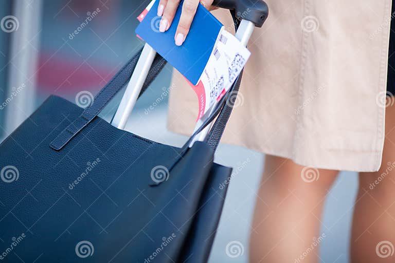 Travel Closeup Of Girl Holding Passports And Boarding Pass At Airport