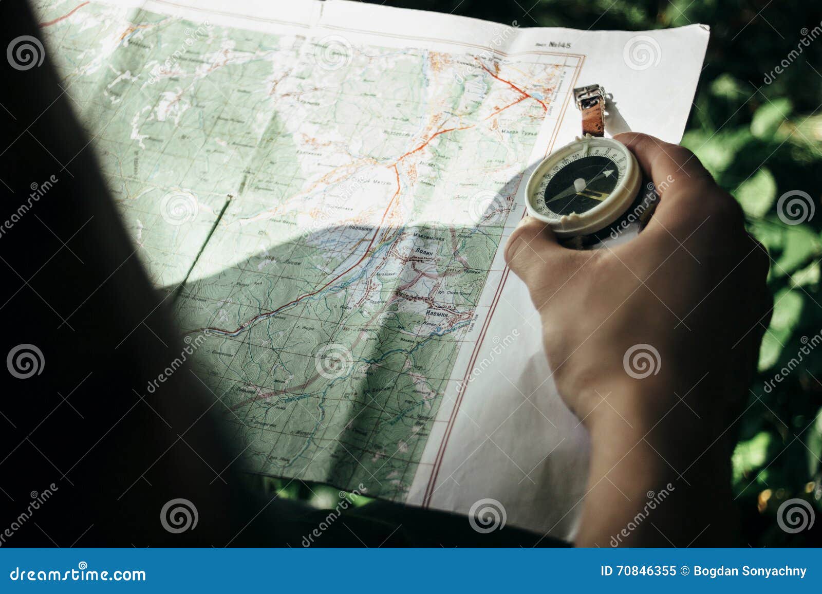 Traveler Exploring Map with Compass in Sunny Forest in the Mount Stock ...