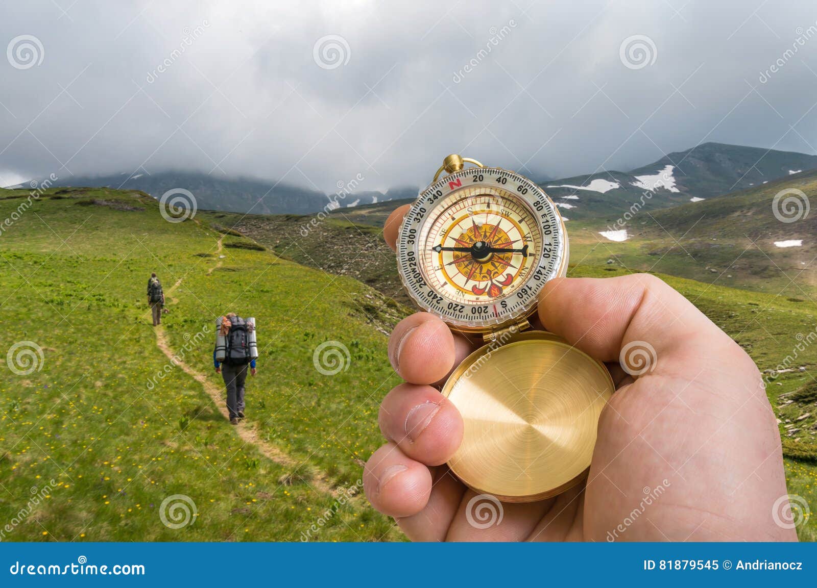 Traveler Man with Compass Seeking a Right Way in the Mountains Stock ...