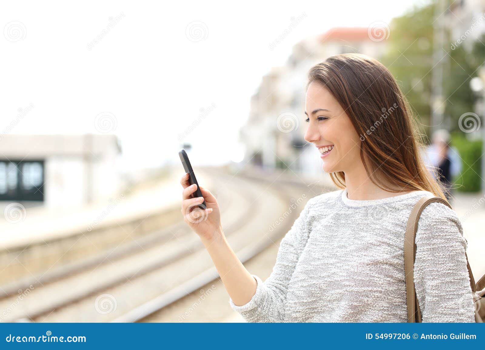 Traveler Using a Smartphone in a Train Station Stock Photo - Image of ...
