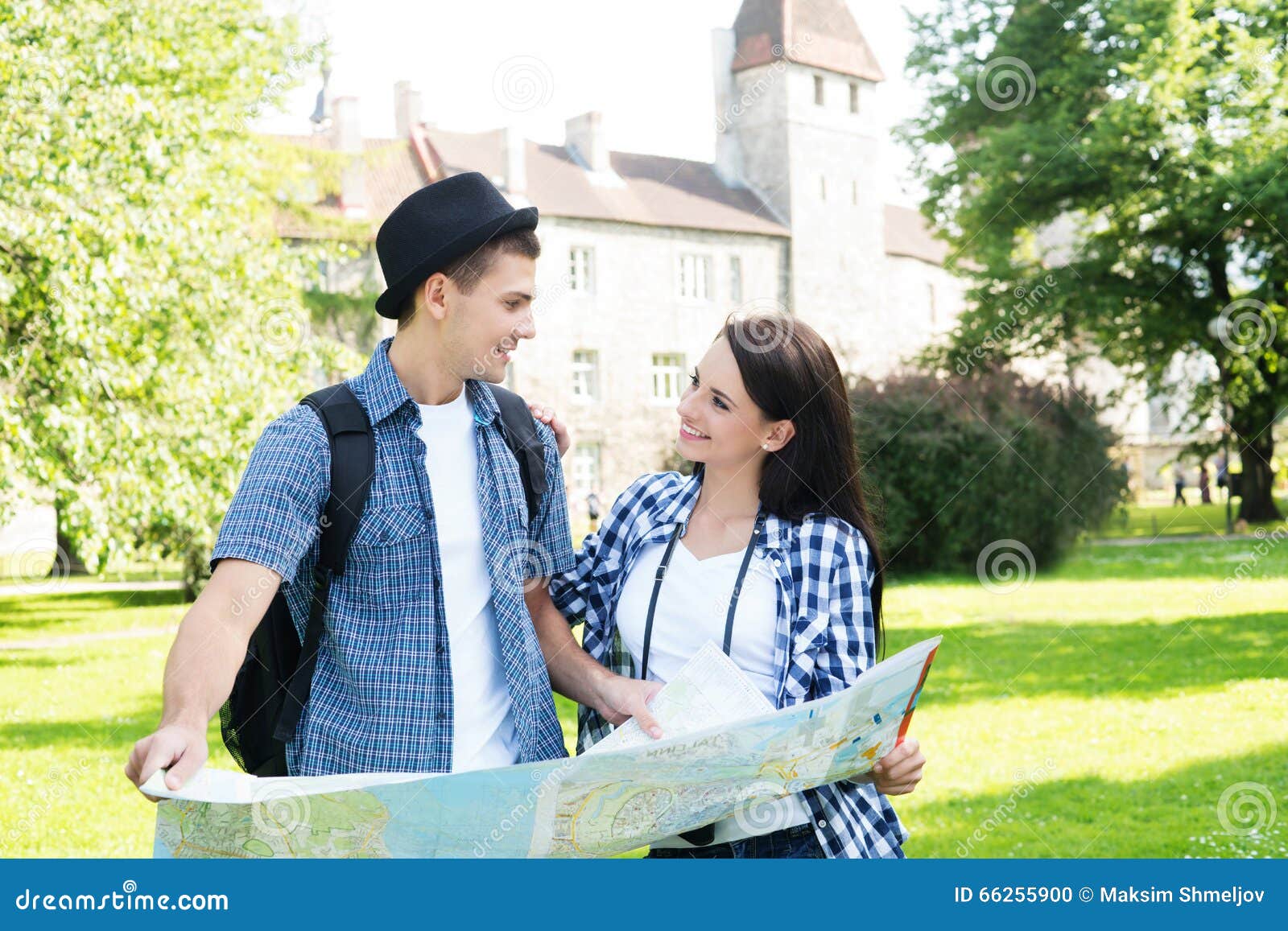 Traveling Couple Searching for Their Next Destination with a Map Stock ...
