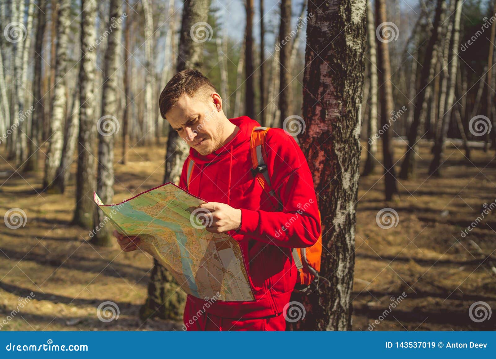 Traveling Man with Map in Woods. Side View of Man with Backpack Reading ...