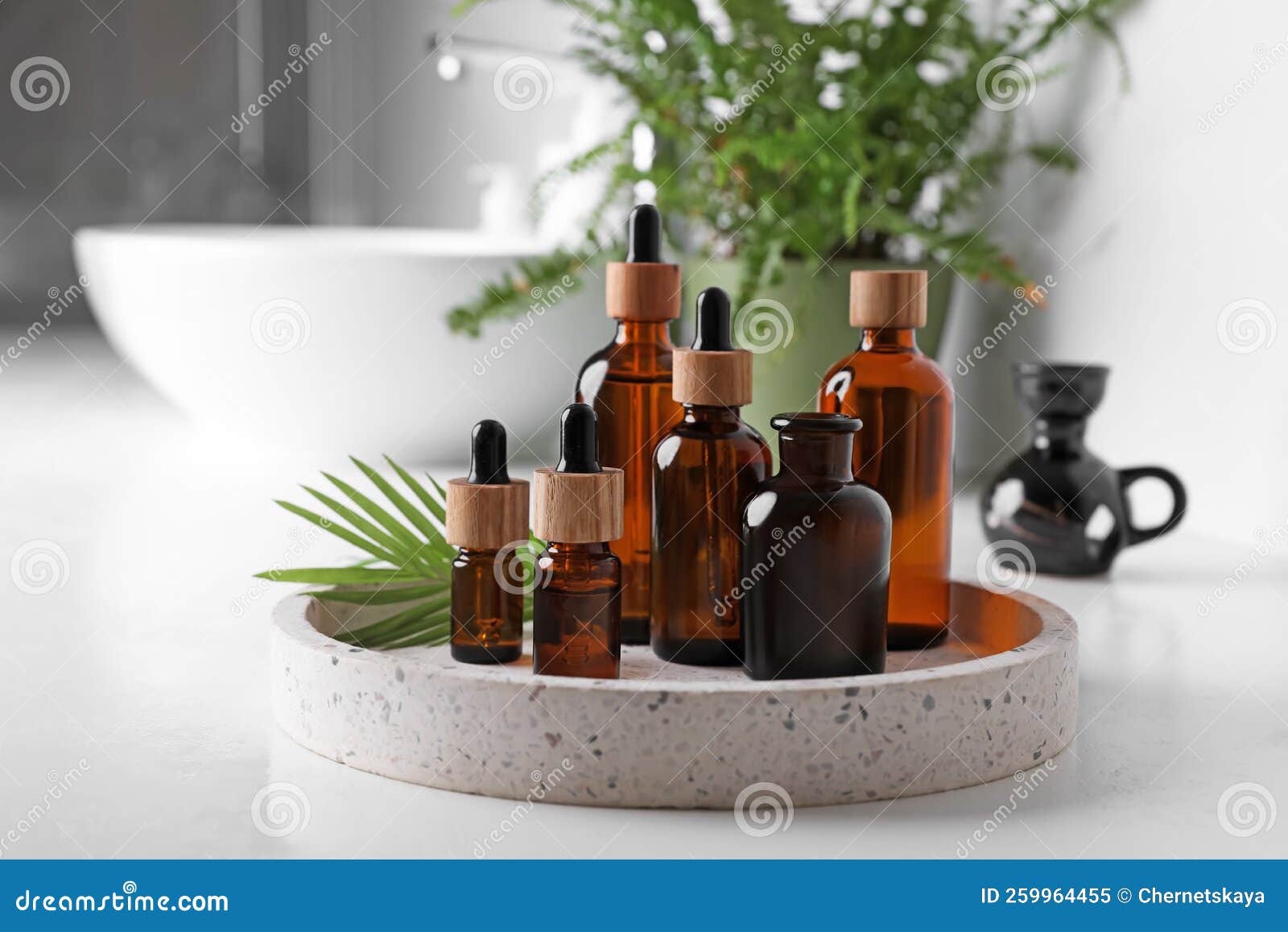 Tray with Bottles of Essential Oils on White Table in Bathroom Stock ...