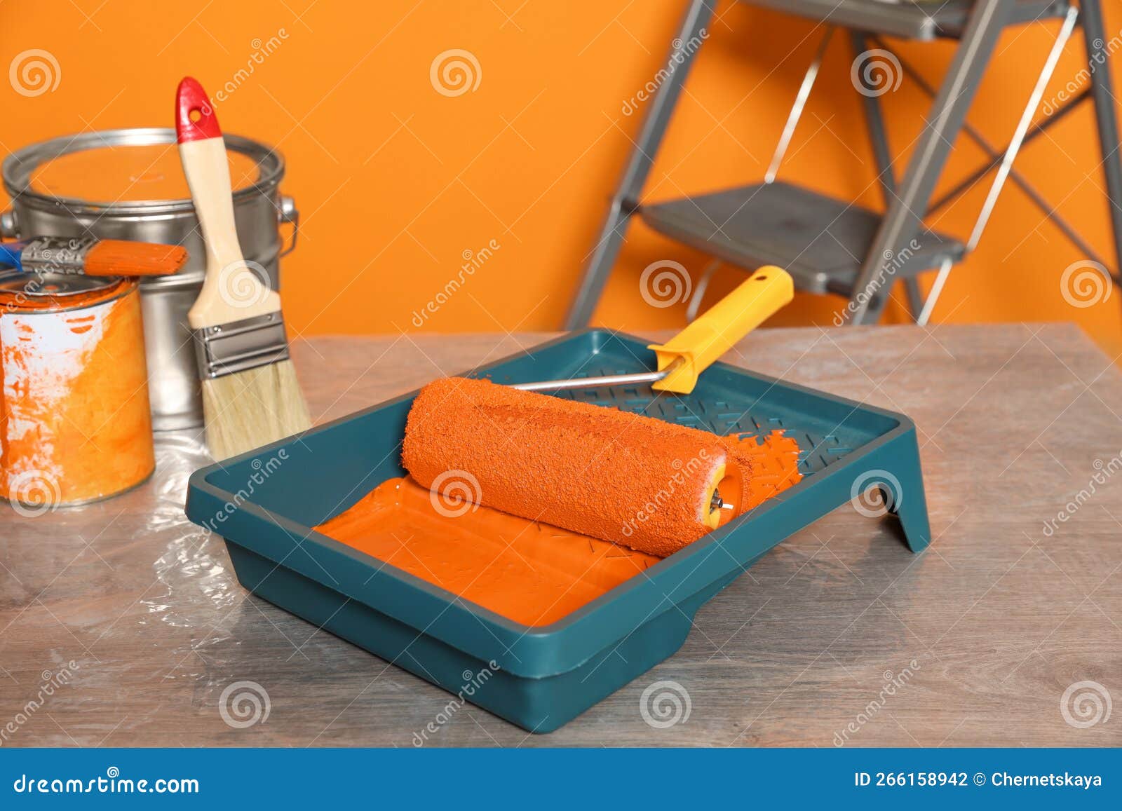 Tray with Orange Paint and Roller on Table Stock Photo - Image of ...