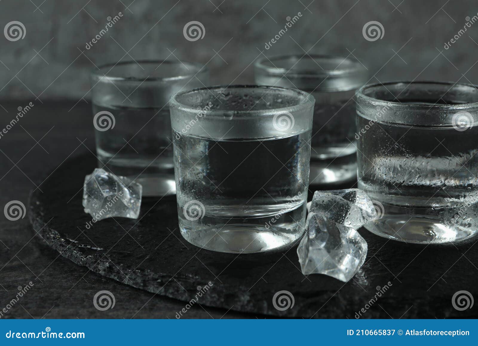 Tray with Wet Shots of Vodka and Ice on Dark Table Stock Image - Image ...