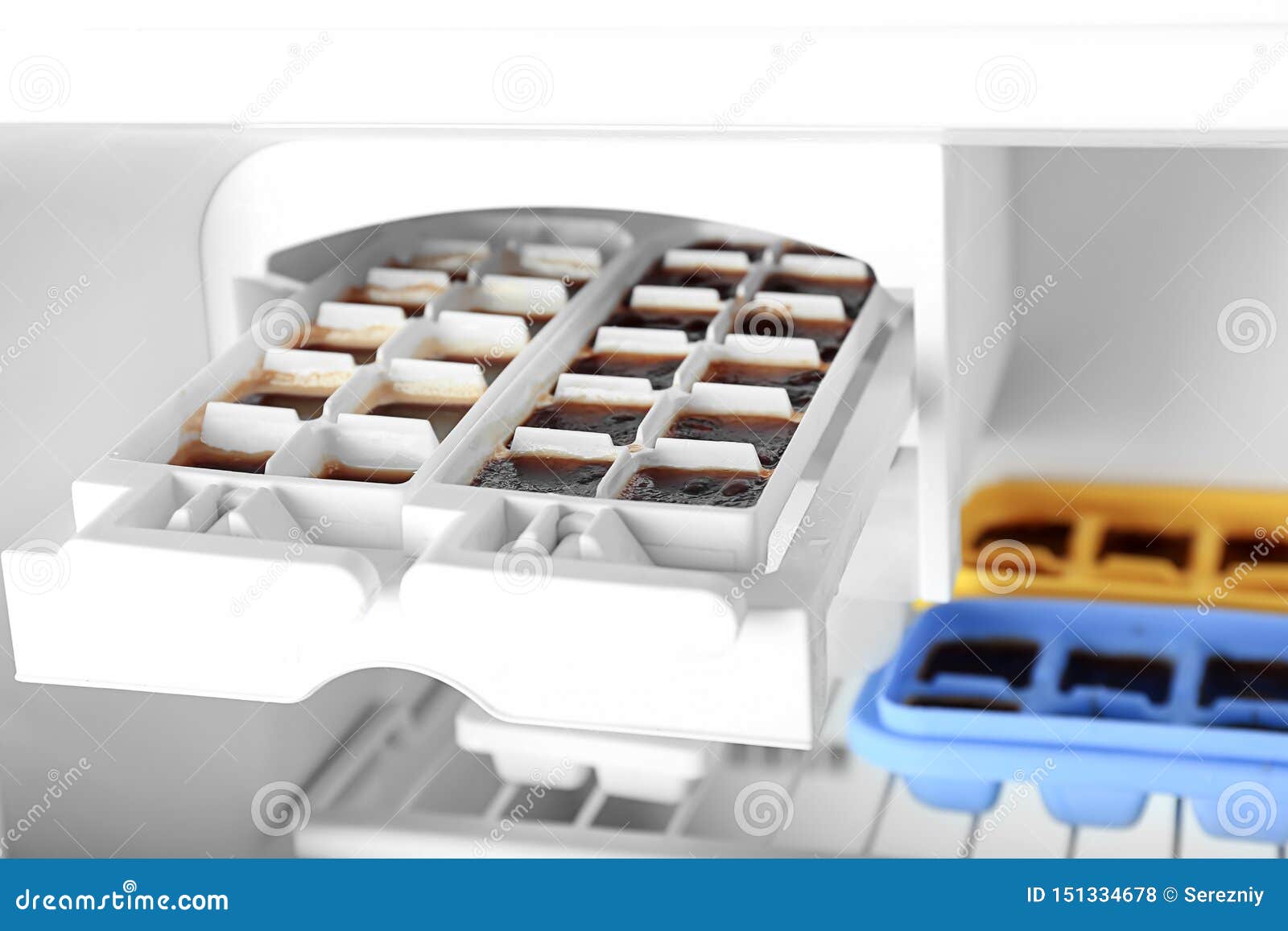 Trays with Coffee Ice Cubes in Fridge Stock Photo - Image of closeup ...
