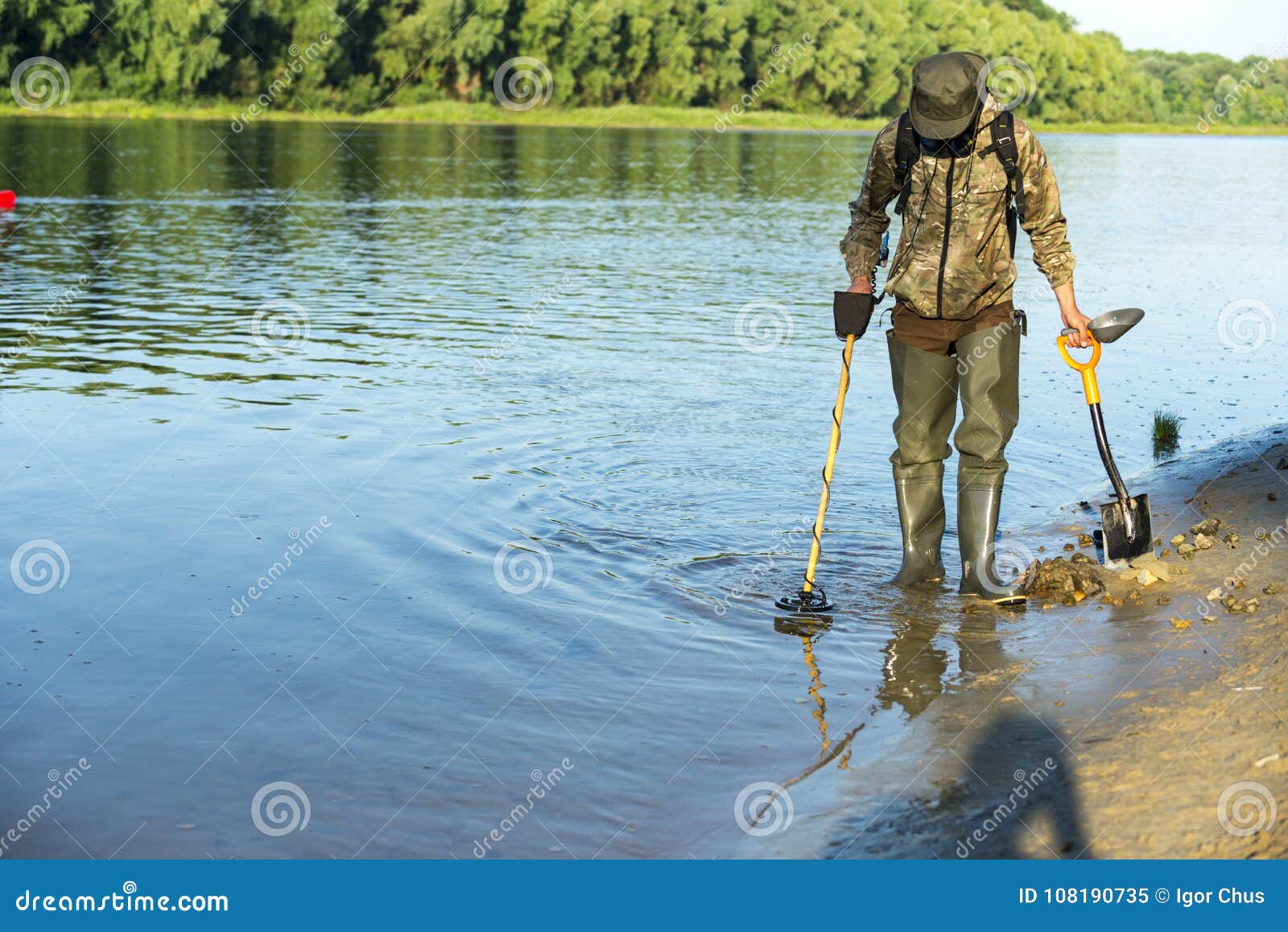 Treasure Hunter is Looking for a Metal Detector in the River Stock ...